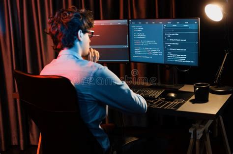 working it developer concentrating online software at neon light room gusher stock image