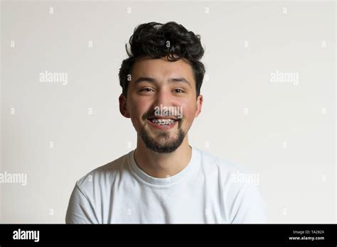 Portrait Of A Young Man With Braces Smiling And Laughing A Happy Young