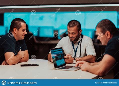 Group Of Security Data Center Operators Working In A Cctv Monitoring