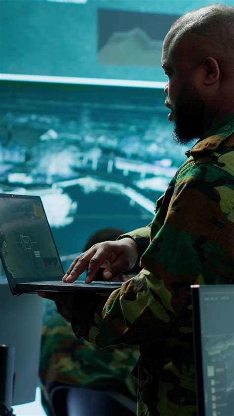 Vertical Military Specialists Work In A High Tech Command Post Center Focusing On Cybersecurity