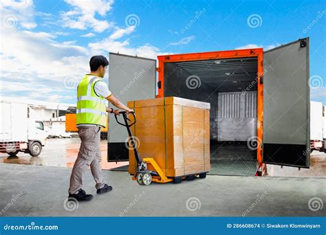 Workers Unloading Heavy Pallet Boxes Into Container Truck Loading Dock Warehouse Supply Chain