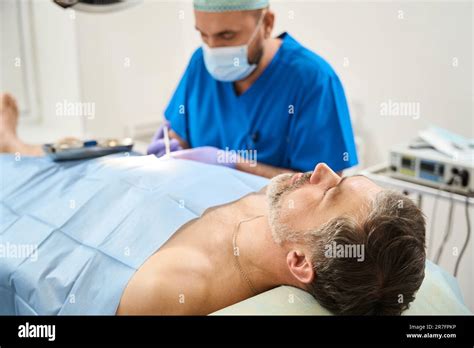 Man On Operating Table To Whom Doctor Injects With Syringe Stock Photo Alamy