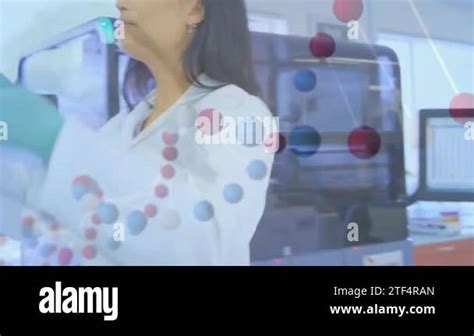 Animation Of Dna Helix Rotating Over Asian Female Scientist Checking