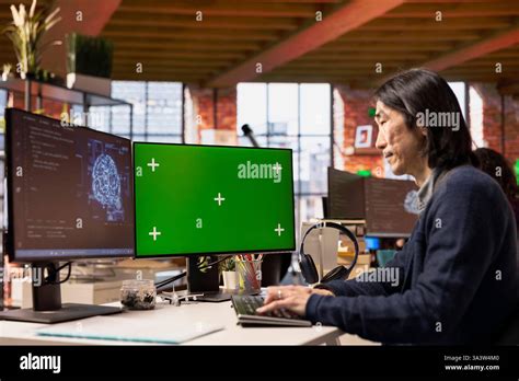 Software Developer In Pioneering Technology Startup Using Green Screen Computer To Oversee