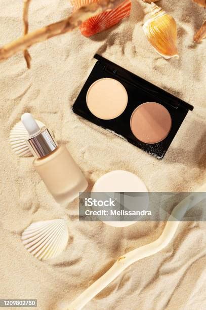 얼굴 여름 화장품 제품 키트입니다 윤곽이 있는 파우더 파운데이션 리퀴드 크림 코튼 스폰지를 황금빛 모래위에 발라줍니다 전문 메이크업 및 뷰티 컨셉 메이크업 화장품에 대한