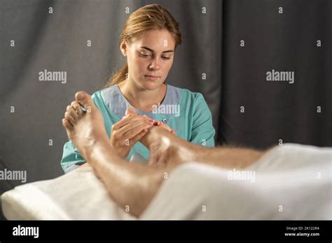 Man Lying And Getting Treatment In Health Center Masseuse Hands Doing