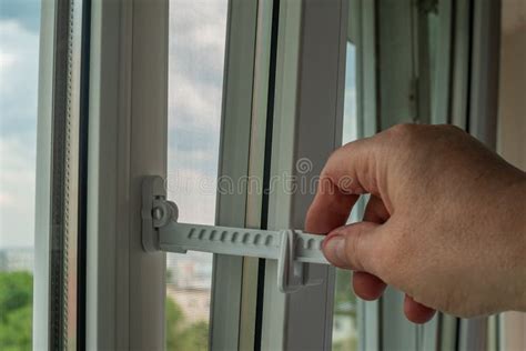 Close Up Of A Manand X27s Hand Adjusting A Window Opening Limiter