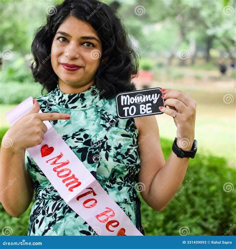 A Pregnant Indian Lady Poses For Outdoor Pregnancy Shoot And Hands On