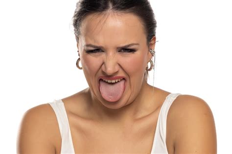 Angry Woman With Dark Hair In White Tank Top Showing Expression Of