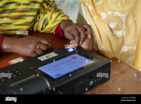A Woman Casts Her Vote Using An Electronic Voting Machine Evm During