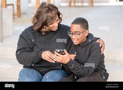 Aunt Showing Nephew Her Phone Stock Photo Alamy