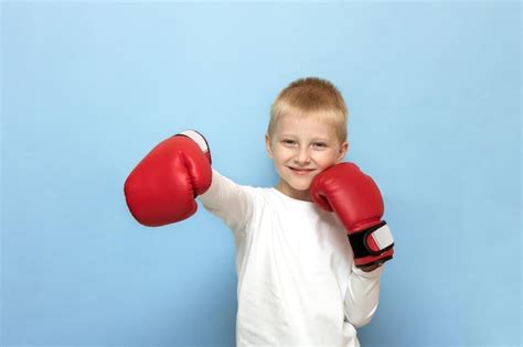 Premium Photo Funny Blond Boy In Red Boxing Gloves Depicts A Boxer