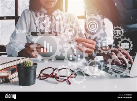 Two Colleagues Discussing Data With New Modern Computer Laptop And