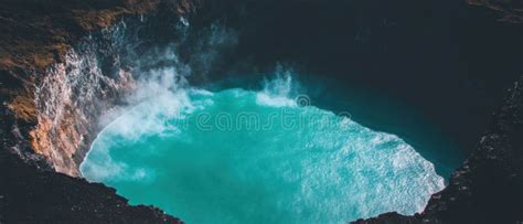 Emerald Green Lake Inside A Volcanic Crater Surrounded By Steep Rocky