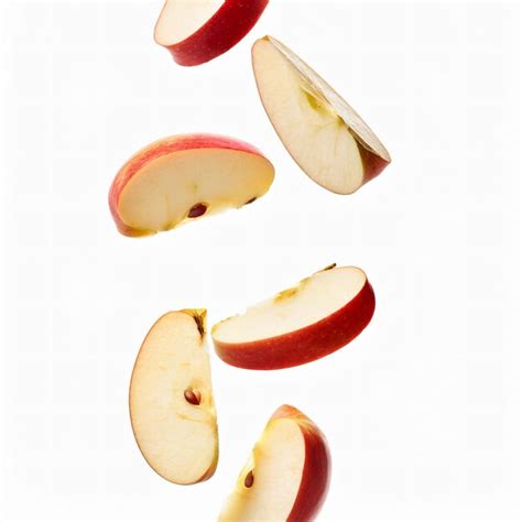 Red Apple Slices Suspended In Midair Premium Ai Generated Image