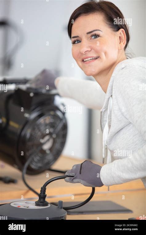 Female Technician Plugs In An Electrical Appliance Stock Photo Alamy