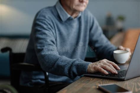 Senior Man Wheelchair Typing On Laptop Keyboard Writing Message At Home