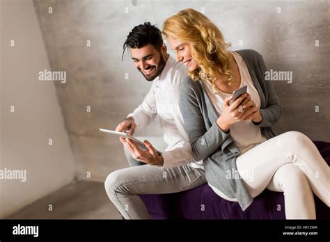 Man Showing Woman Information On Tablet And Girl Holding Smartphone Stock Photo Alamy