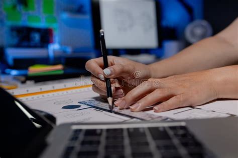 An Engineer Is Working In A Private Office With Documents Spread Across