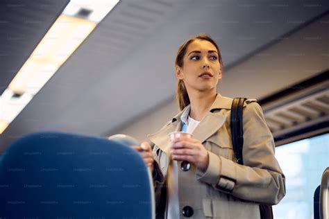 테이크아웃 커피를 들고 기차로 여행하며 시선을 돌리는 젊은 여성 승객 사진 Unsplash의 세르비아 이미지