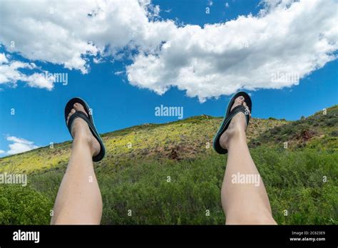 Woman Playfully Holding Her Legs Up In The Air Stock Photo Alamy