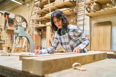 Focused Craftswoman Planning Details In A Busy Woodworking Workshop Stock Image Image Of