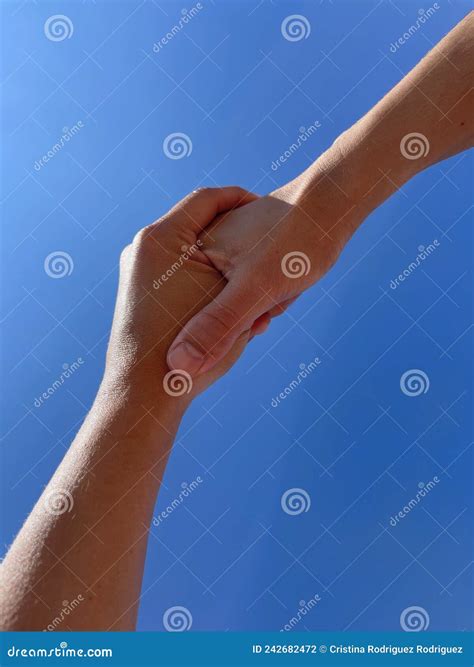 Dos Mujeres Cogidas De La Mano Con Fondo Azul Del Cielo Foto De Archivo Imagen De Hombres