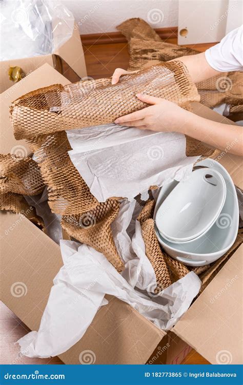 Detail Of Woman Packaging Fragile Items Using Crumpled Packing Paper Stock Image Image Of