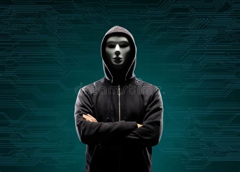 Computer Hacker In Mask And Hoodie Over Abstract Binary Background Obscured Dark Face Stock