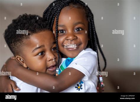 Cute Girl Embracing Brother At Home Stock Photo Alamy