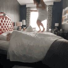 Girl Jumping On The Bed In Towel 