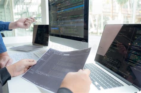 Programmers Work On The Development Of Coding And Coding Technology On White Desks And Website