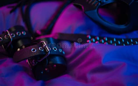 Leather Bdsm Handcuffs And Accessories For Bdsm Games In Neon Light