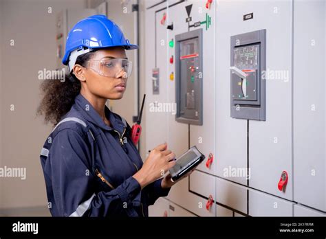 Electrical Young Asian Woman Engineer Examining Maintenance Cabinet System Electric And Using