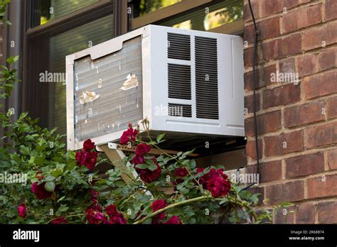 Exterior View Of Air Conditioning Window Unit Extruding From The Window