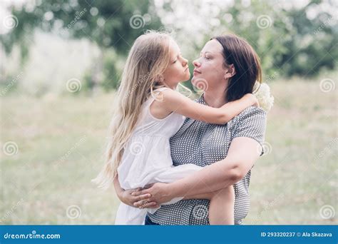 Mom Holds Her Daughter In Her Arms Plays Looking At Each Other Stock