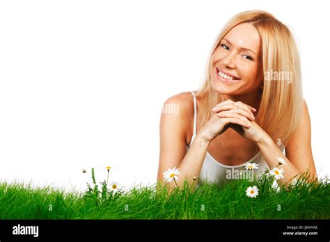 Beautiful Young Blonde Woman Lying On Grass With Chamomile Flowers Isolated On White Background