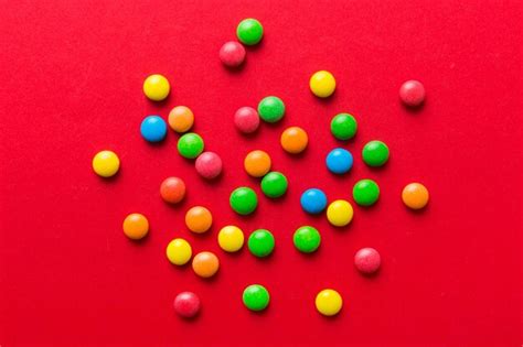Premium Photo Mixed Collection Of Colorful Candy On Colored