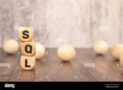 Wooden Cubes On A Brown Background With The Text Sql Represent The