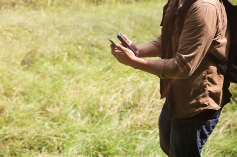 스마트 폰과 배터리 충전기와 관광은 여름 숲에서 길을 찾고 있습니다 전원 은행와 남자는 자연에서 손실 됩니다 현대 기술 개념은 항상 온라인 및 터치에 머물 수 있습니다
