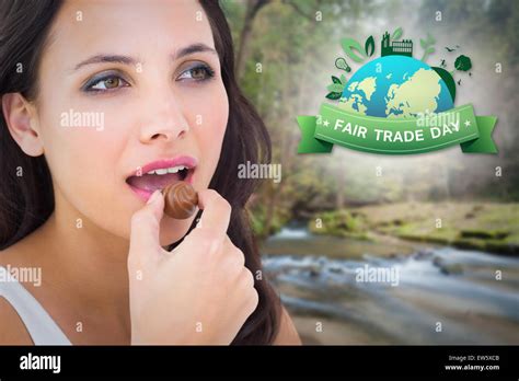 Composite Image Of Pretty Brunette Eating Chocolate Candy Stock Photo Alamy