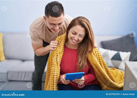 Man And Woman Mother And Son Using Touchpad Sitting On Sofa At Home Stock Image Image Of
