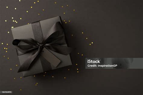 검은 색 새틴 리본 리본 활 태그와 빈 공간이있는 고립 된 검은 색 배경에 황금 색종이가있는 블랙 패키징의 기프트 박스 의 상단 보기 사진 선물 상자에 대한 스톡 사진 및