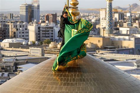 تصویر تعویض پرچم گنبد حرم امام رضا