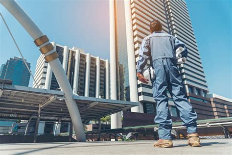 엔지니어 남자 손 은 건설 공학에 대한 하드 햇 흰색 작업 헬멧 하드 모자를 들고 안전 정장 손에 건설 엔지니어 남자는 현장