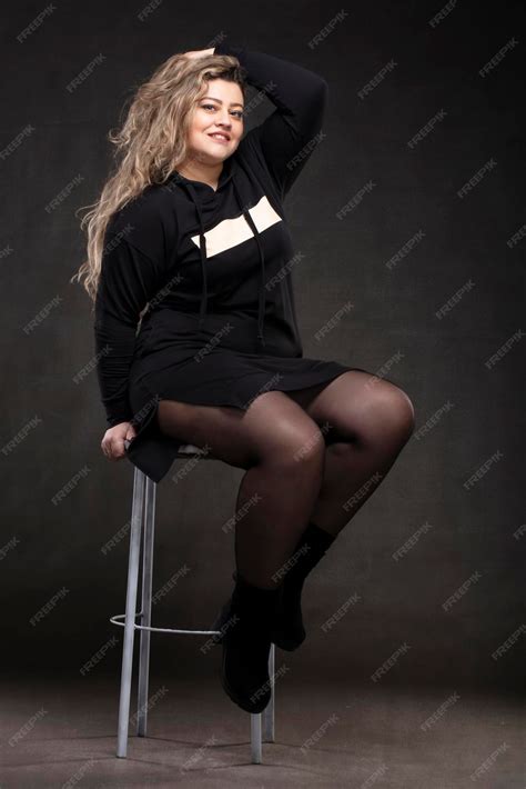 Premium Photo Beautiful Fat Woman With Long Curly Hair In Black