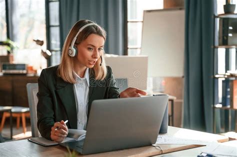 Using Laptop Young Beautiful Woman In Formal Clothes Is Working In The Office Stock Image