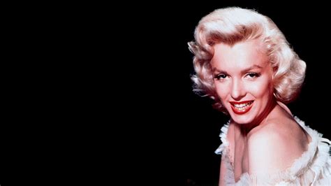 Marilyn Monroe In Black Background Facing One Side Wearing White Dress