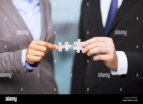 Businessman And Businesswoman With Puzzle Pieces Stock Photo Alamy