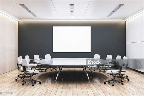 현대적인 기업 회의실 인테리어에는 대형 원형 테이블과 어두운 벽에 빈 포스터 프레임이 있어 디자인 모형 및 프레젠테이션 레이아웃을 제공합니다 3d 렌더링 0명에 대한 스톡